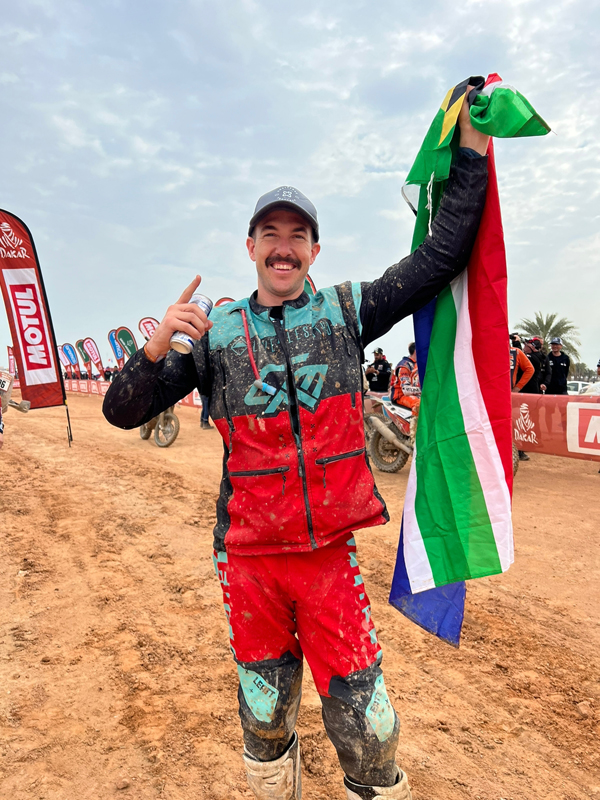Charan Moore crosses the finish line of the final stage and wins the ...